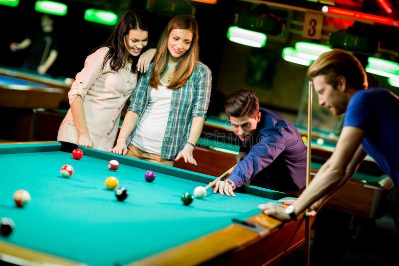 Young people playing pool stock photo. Image of beautiful - 53279672