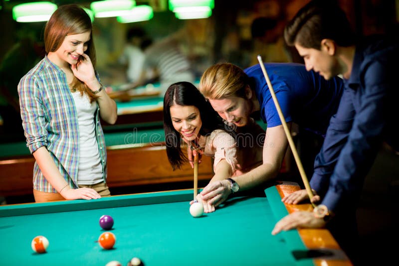 Young people playing pool stock image. Image of playing - 53314881