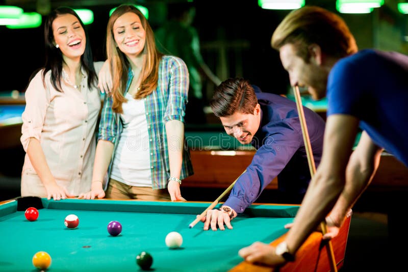 Young people playing pool stock image. Image of relaxation - 53710709