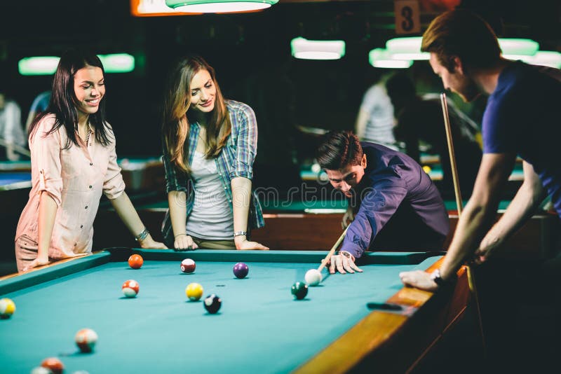 Young people playing pool stock photo. Image of nightclub - 53133170