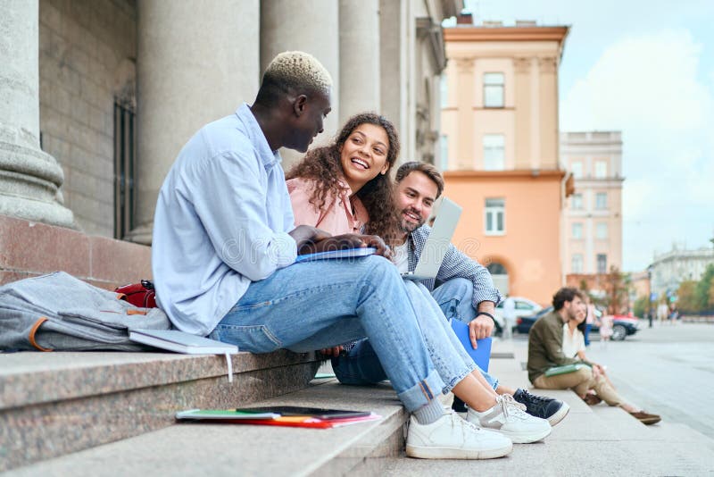 Young People Share the News Sitting on the Steps. Stock Photo - Image ...