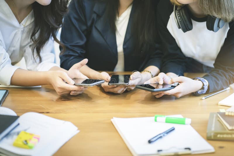 Young People Sharing Smart Phone Content Together. Stock Image - Image ...