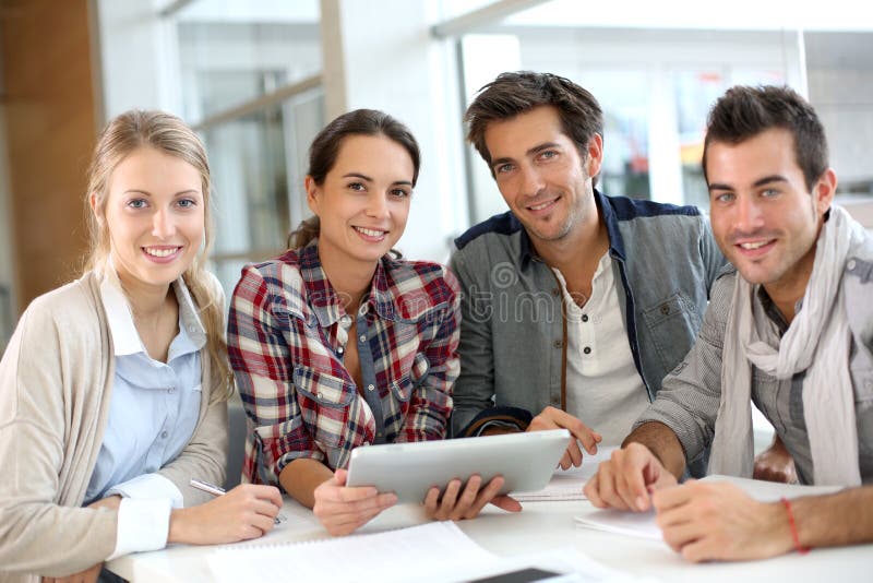 Young People Sitting at the Table and Using Tablet Stock Image - Image ...