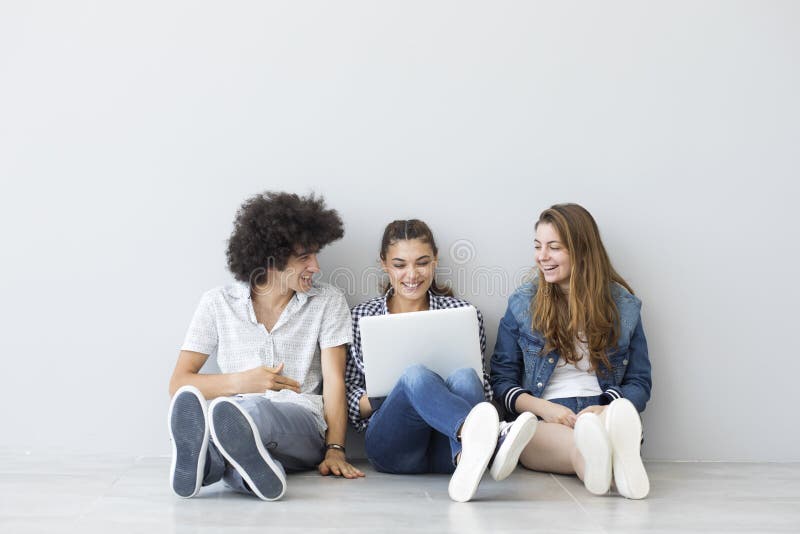 Young People Sitting and Talking with a Computer Stock Photo - Image of ...