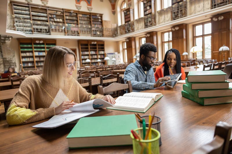 Young People Studying in the Library and Looking Involved Stock Photo ...