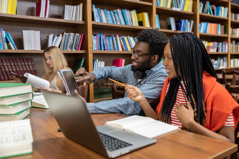 Young People Studying in the Library and Looking Involved Stock Photo ...