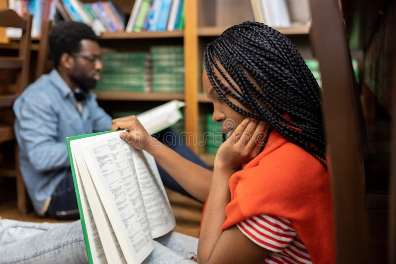 Young People Studying in the Library Together and Looking Involved ...
