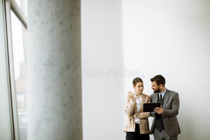 Young People with Tablet by the Wall in the Office Stock Image - Image ...