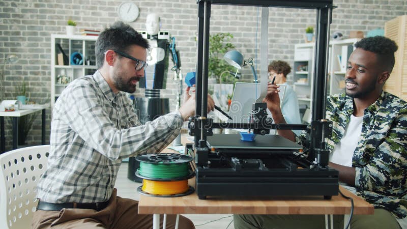 Young People Talking Watching 3d Printer Modeling Plastic Detail for ...