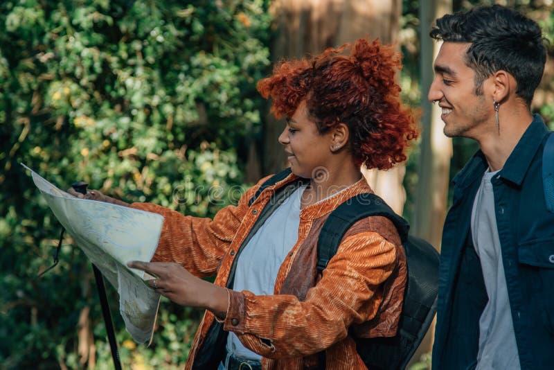 People Traveling Looking at the Map Outdoors with Backpacks Stock Image ...