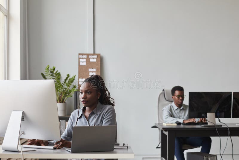 Young People Using Computers in Office Stock Photo - Image of laptop ...
