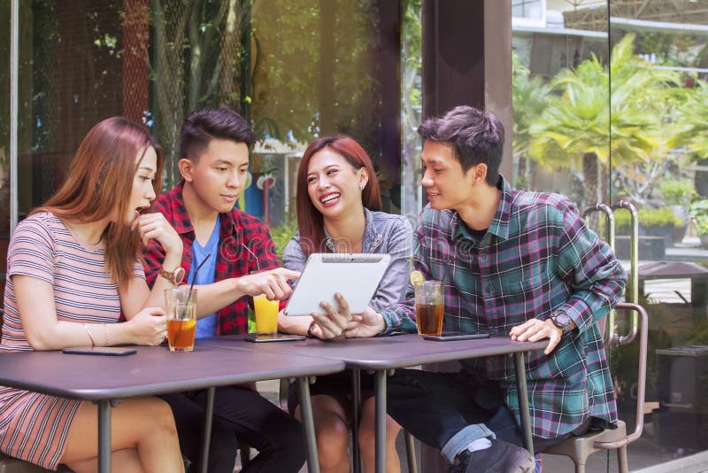 Young People Using a Digital Tablet in Cafe Stock Image - Image of ...