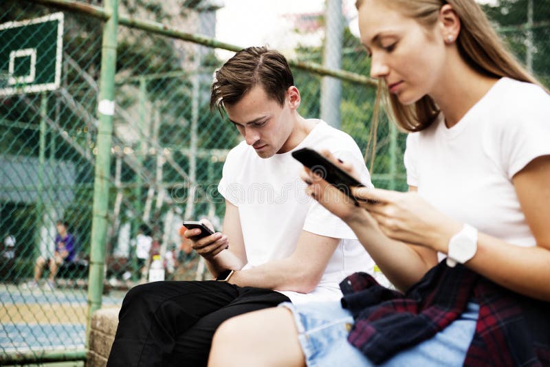 Young People Using Mobile Phone Stock Image - Image of checking, couple ...