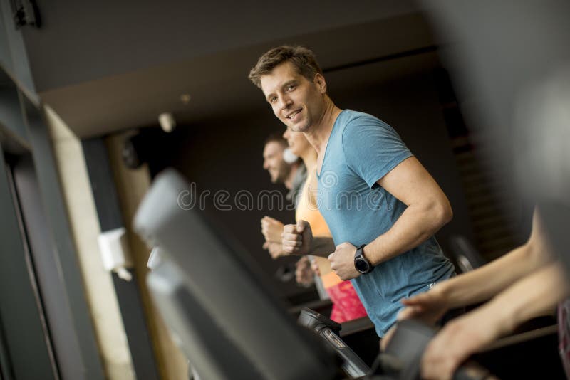 Young People Using Threadmill in Modern Gym Stock Image - Image of ...