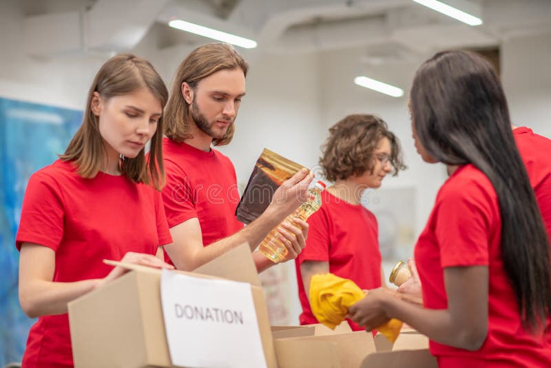 Young People Working in a Donations Distribution Center Stock Photo ...
