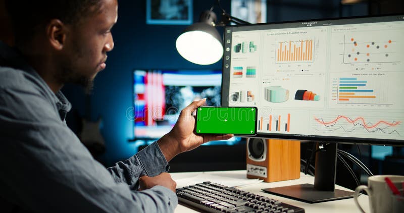 Young Person Does Remote Work Using Data Finances with a Green Screen ...