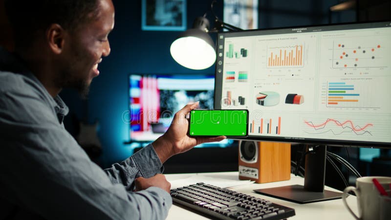 Young Person Does Remote Work Using Data Finances with a Green Screen ...