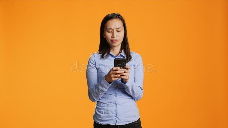 Young Person Texting Messages on Mobile Device in Studio Stock Image ...