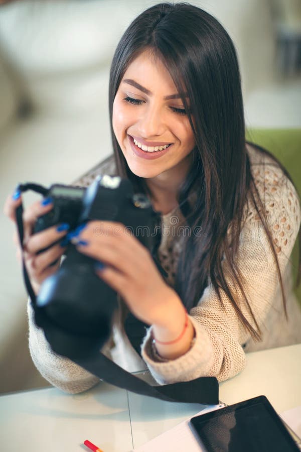 Young Photographer Looking at Her Camera Stock Photo - Image of ...