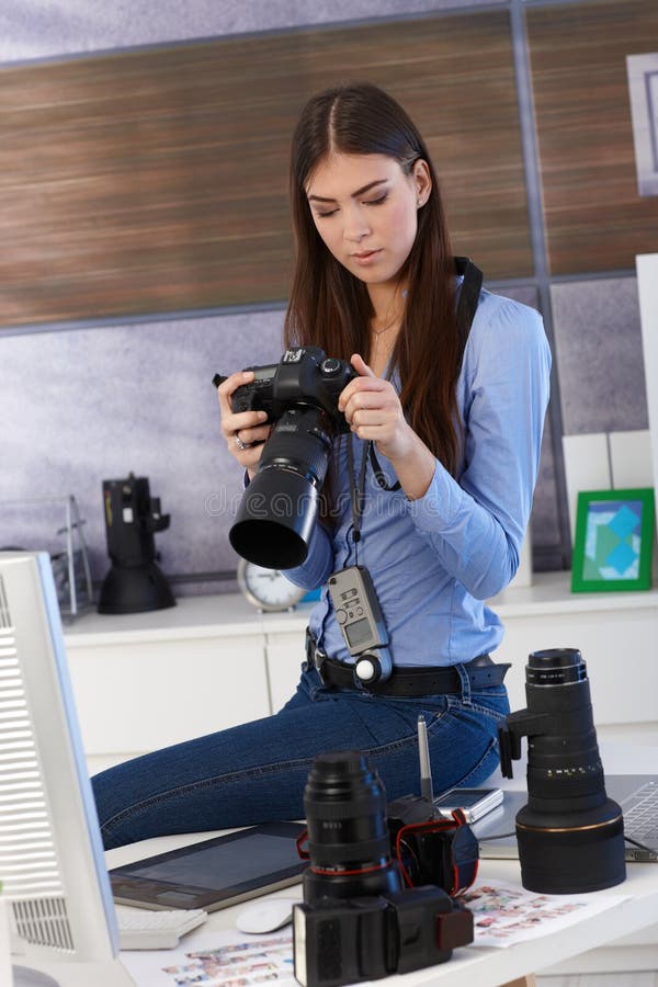 Young photographer at work stock image. Image of checking - 24589749