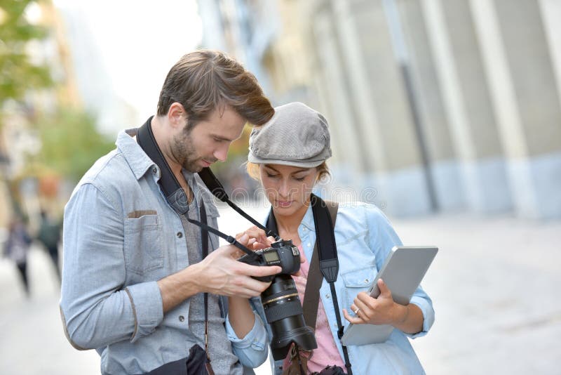 Young Photographers Using Camera and Tablet Stock Photo - Image of ...