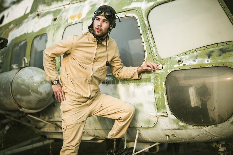 Young Pilot Posing Near the Helicopter Stock Photo - Image of lighting ...
