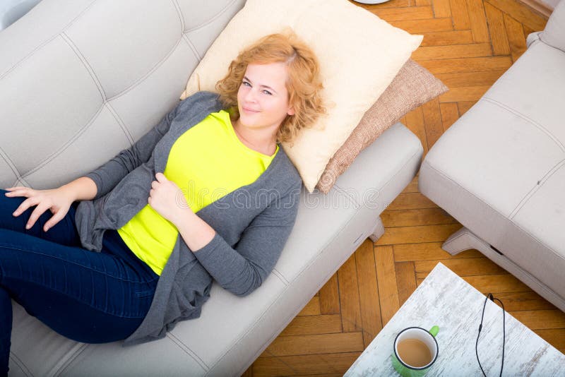 Young Plus Size Woman Relaxing on the Sofa Stock Image - Image of ...