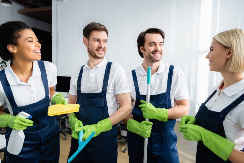 Young Positive Multiethnic Cleaners Talking in Stock Photo - Image of ...
