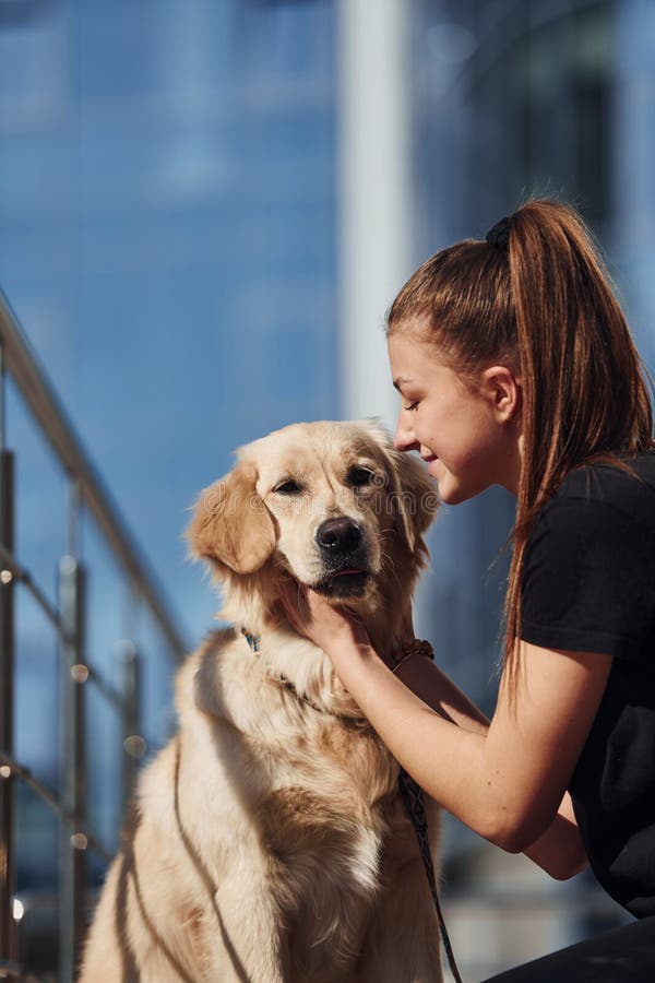 Young Positive Woman Sitting on Stairs with Her Dog when Have a Walk ... Young Positive Woman Sitting on Stairs with Her Dog when Have a Walk ...