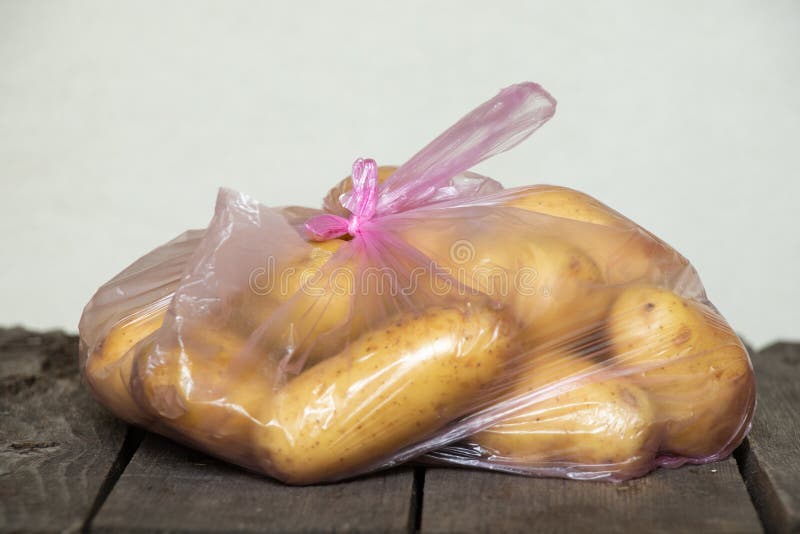 A Young Potato in a Bag on a Table Bought at a Bazaar Closeup Stock ...