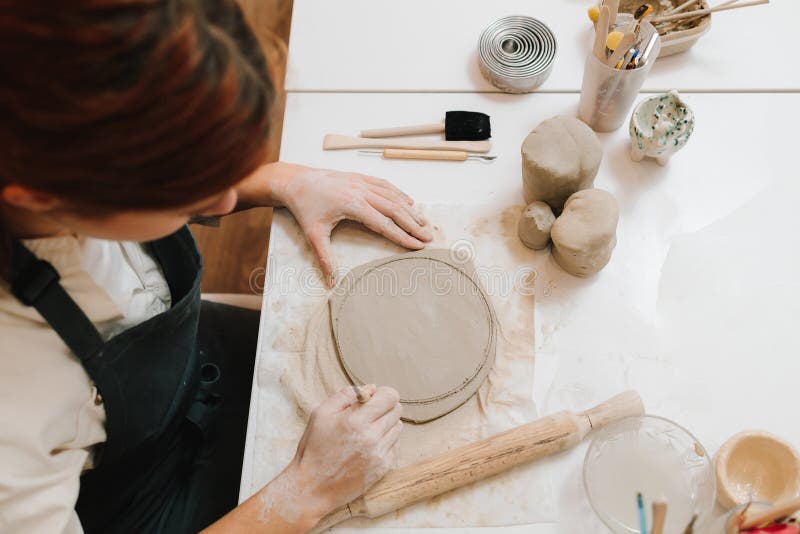 Young Potter Cuts a Circle of Clay with Pottery Tool in the Workshop ...
