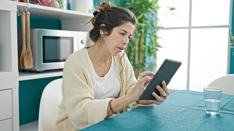 Young Pregnant Woman Touching Belly Using Touchpad at Dinning Room ...