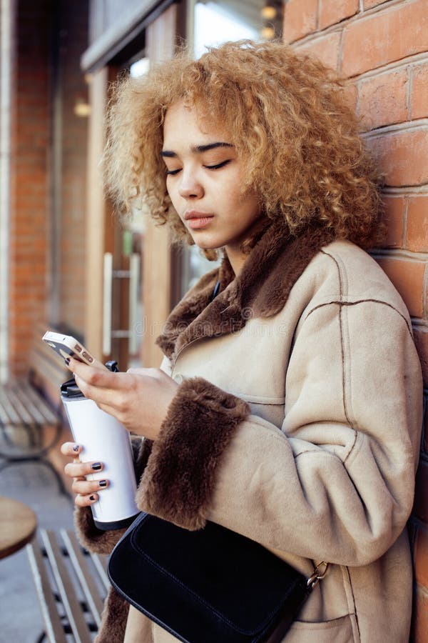 Young Pretty African American Women Drinking Coffee Outside In Cafe