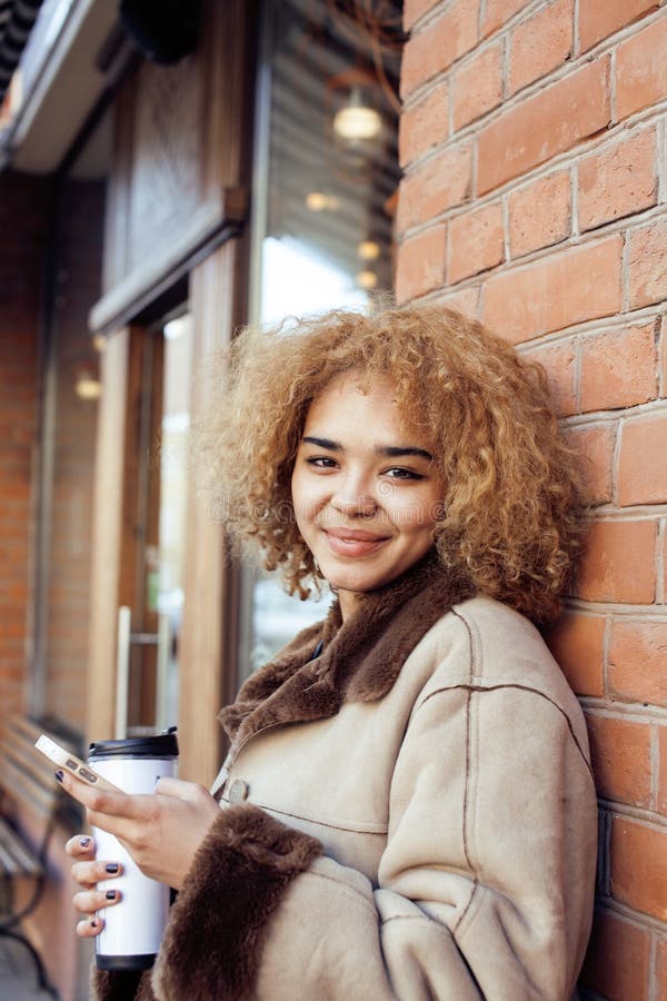 Young Pretty African American Women Drinking Coffee Outside In Cafe