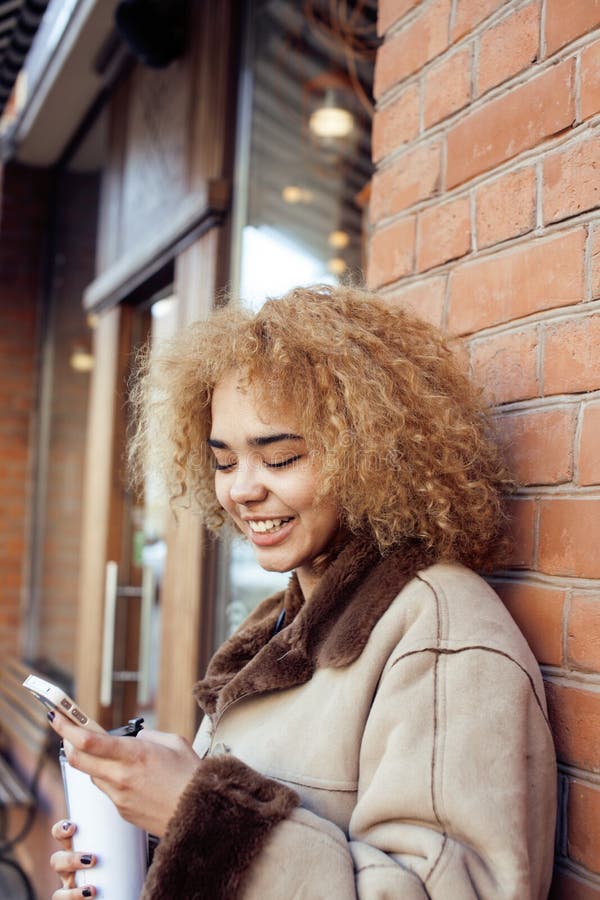 Young Pretty African American Women Drinking Coffee Outside In Cafe