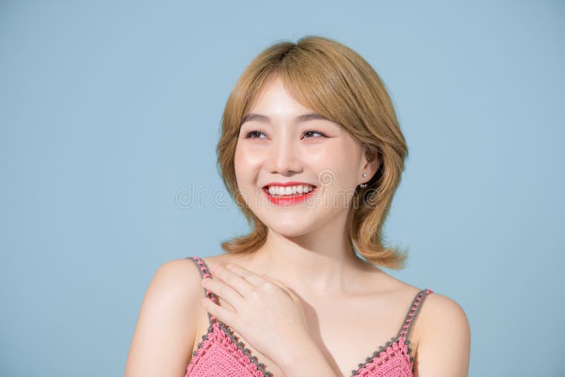 Young Pretty Asian Woman Cute Face Expression Posing On Pastel Blue