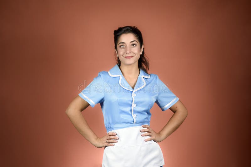 Young Waitress in Blue Uniform, Looking at the Camera with Her Arms ...