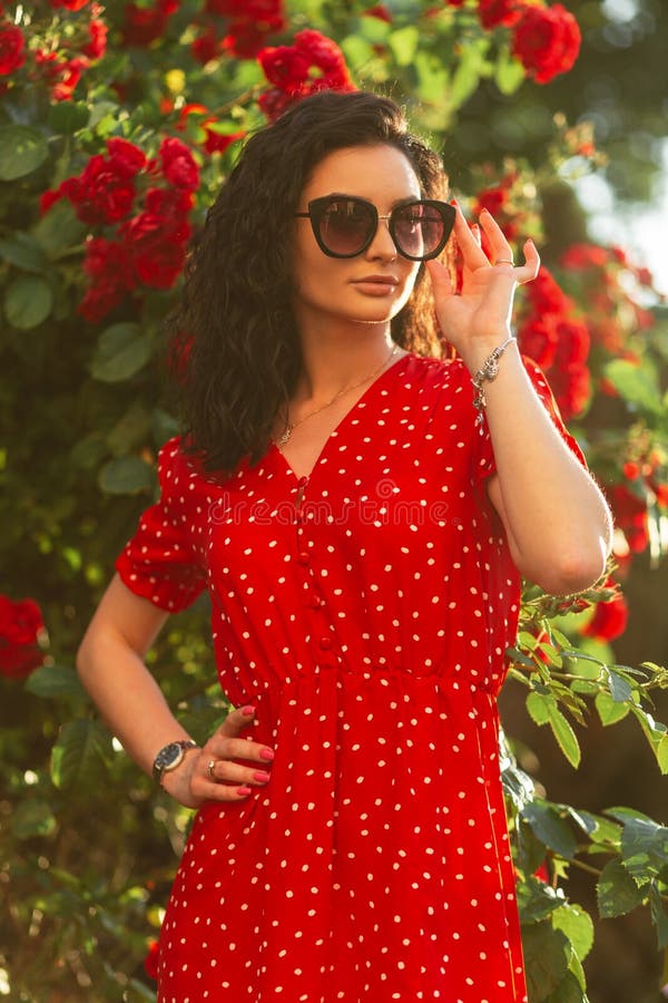 Young Pretty Elegant Woman With Fashion Sunglasses In Red Dress With