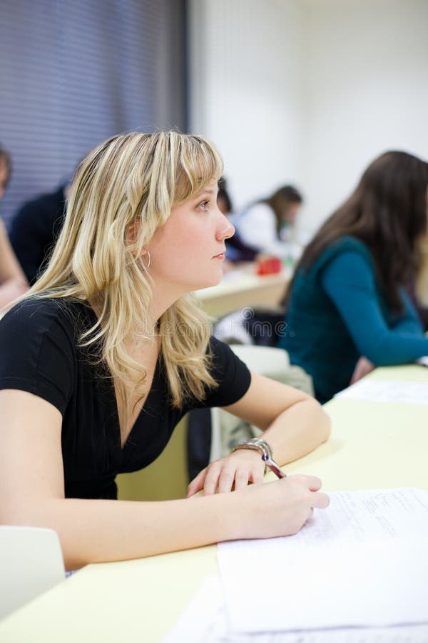Semale Student with Others Writing Notes in Classroom Stock Photo ...