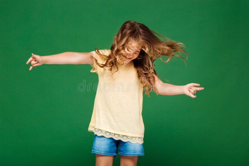 Young Pretty Girl Dancing Over Green Background. Stock Image - Image of ...