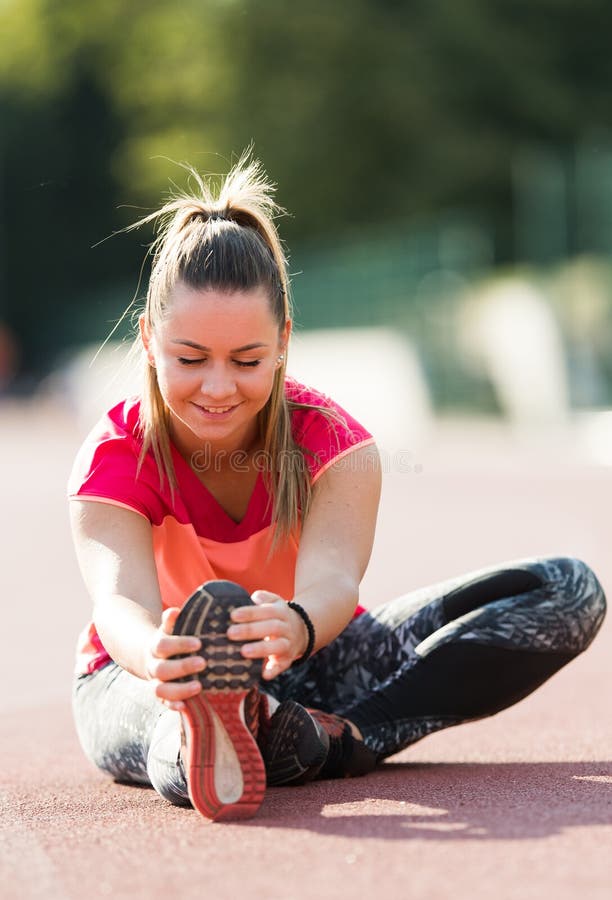 Young Pretty Girl Doing Exercises at Sport Field Stock Image - Image of ...