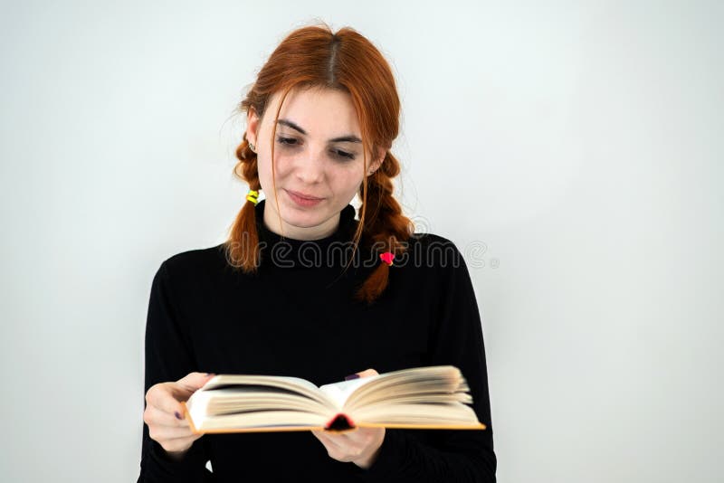 Young Pretty Girl Read an Open Book in Her Hands. Reading and Education ...