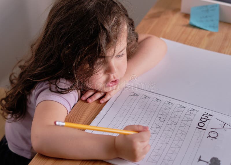 Expressive Young Girl is Doing Her Homework Stock Photo - Image of ...