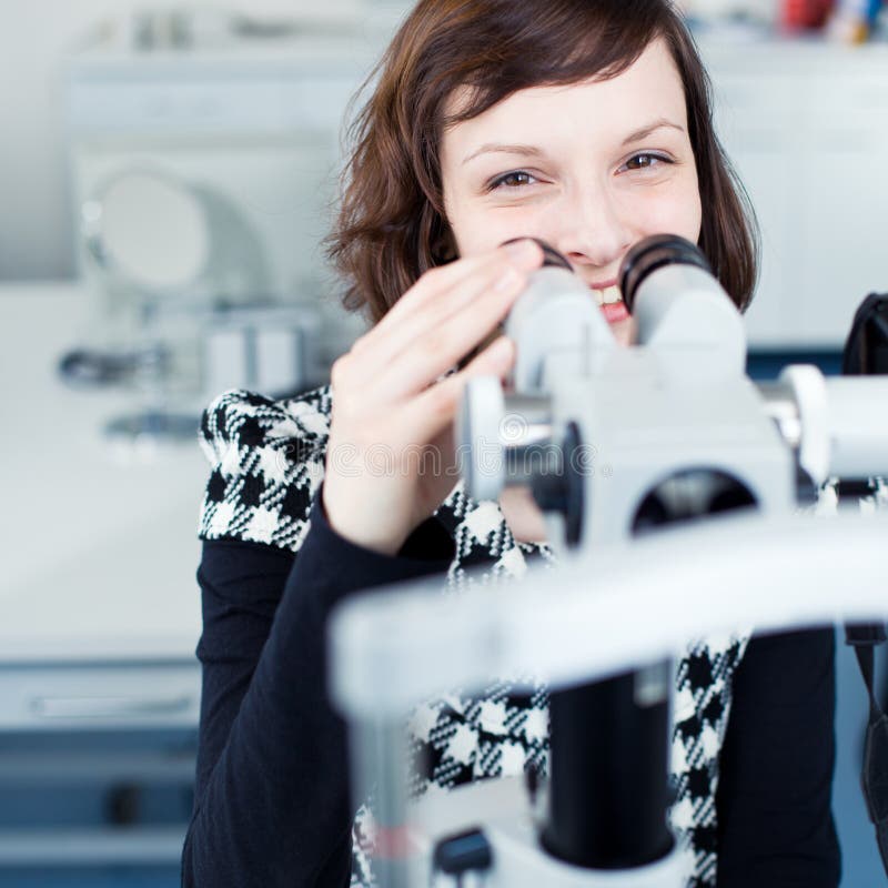 Young Pretty Optometrist Using a Slit Lamp Stock Photo - Image of ...