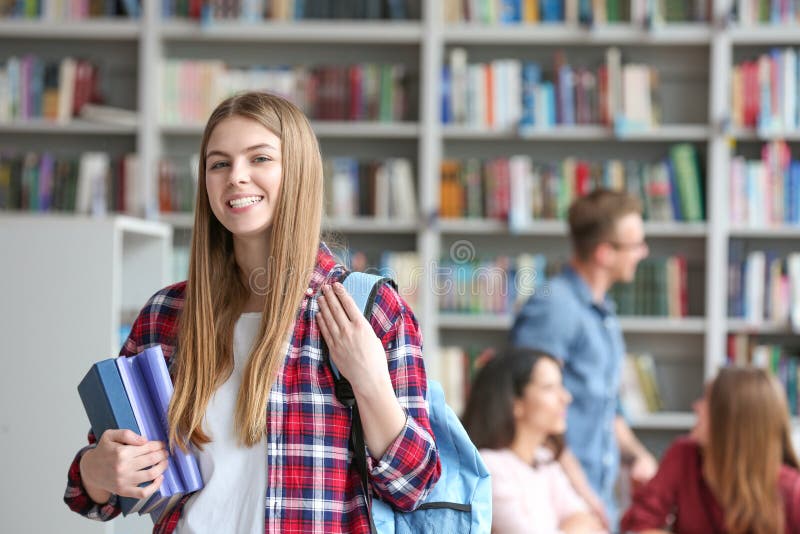 Young Pretty Woman with Books and Backpack in Library Stock Image ...