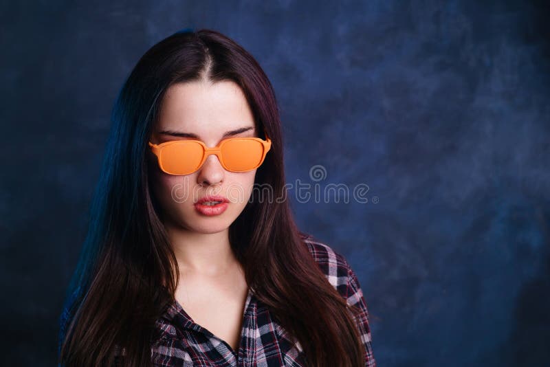 Young Pretty Woman Wearing Bright Orange Retro Styled Sunglasses Stock