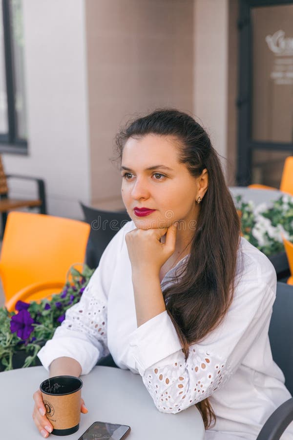 A Young Pretty Woman Works in a Cafe. she is Having a Good Time in the ...