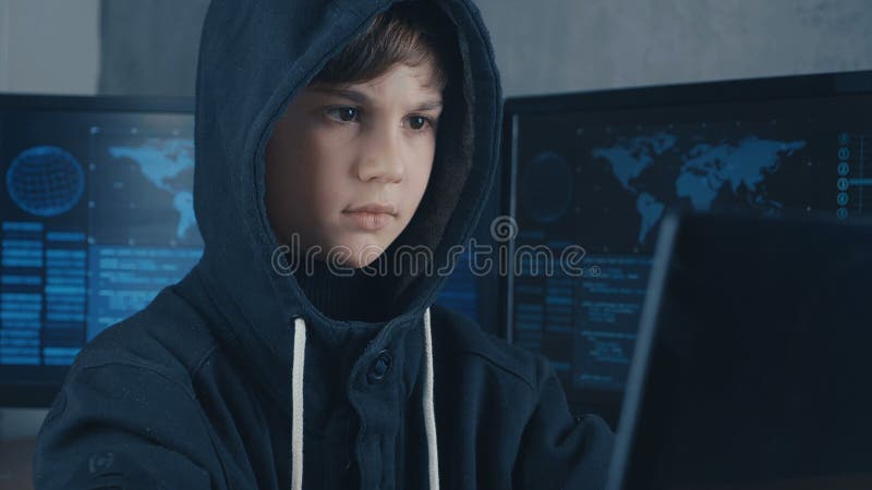 Young Prodigy Boy Hacker Programmer in Hood Working at the Computer in ...