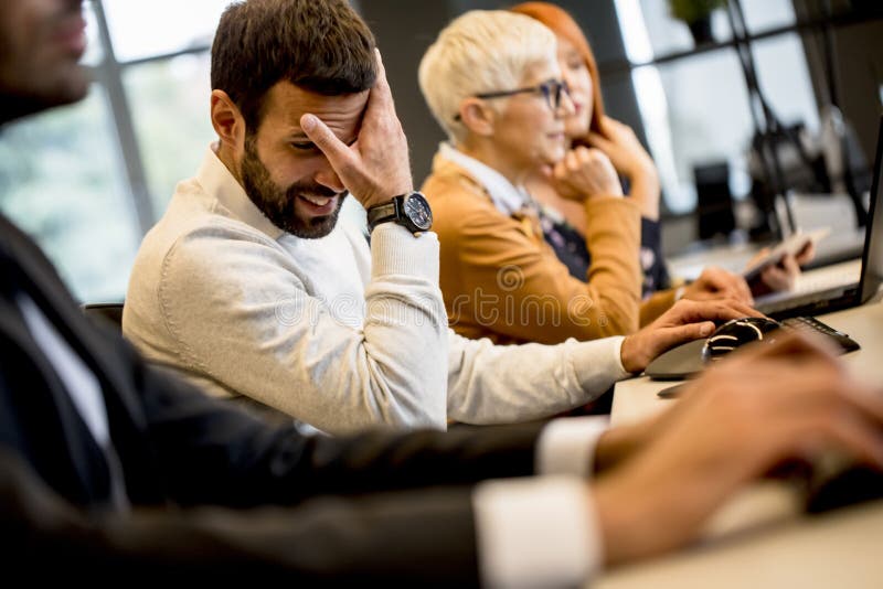 Young Professional Businessman Under Stress Uses a Computer for Work in ...