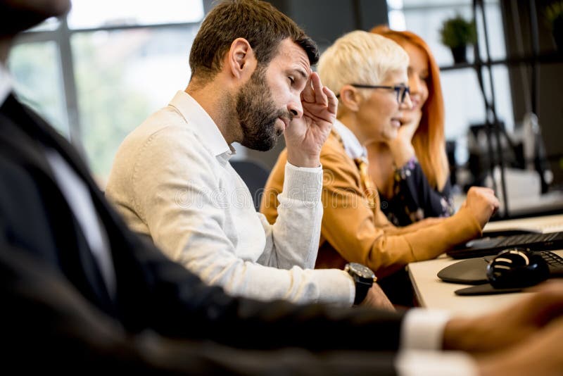 Young Professional Businessman Under Stress Uses a Computer for Work in ...